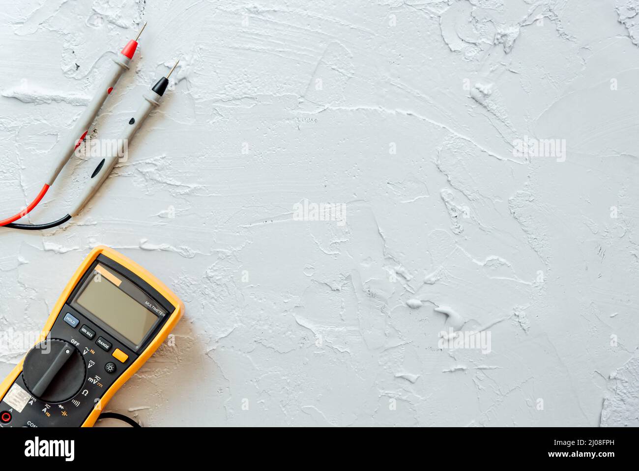 Yellow Digital multimeter with probes on white background with free ...