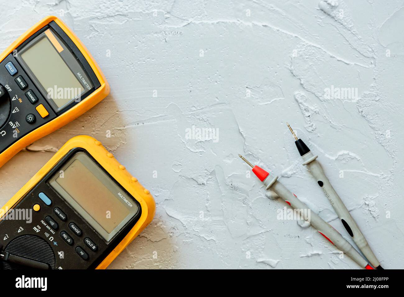 Yellow Digital multimeter with probes on white background with free ...