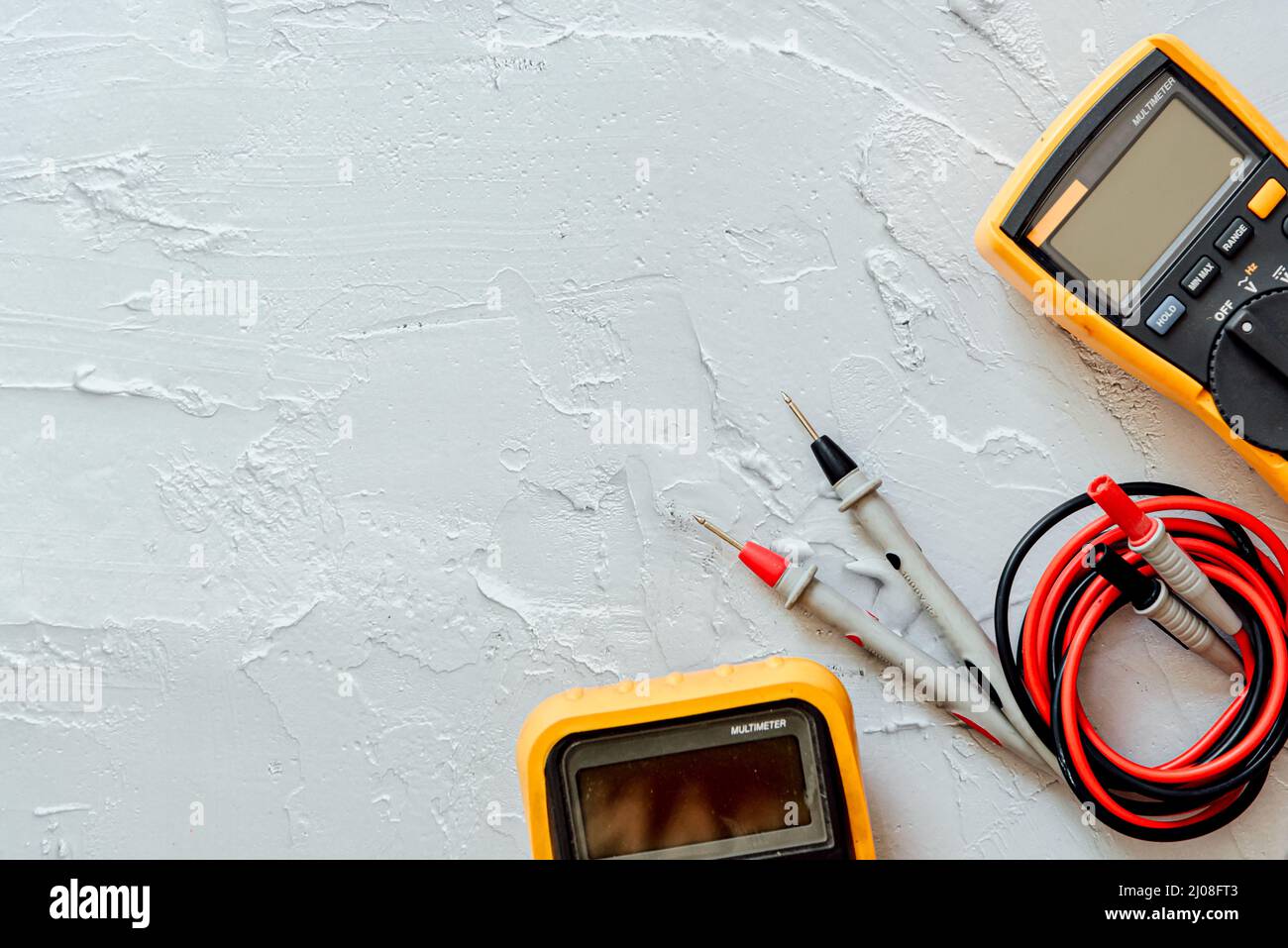 Yellow Digital multimeter with probes on white background with free ...