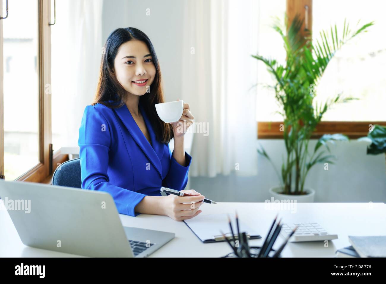 Manager, entrepreneur, female employee sitting and drinking coffee ...