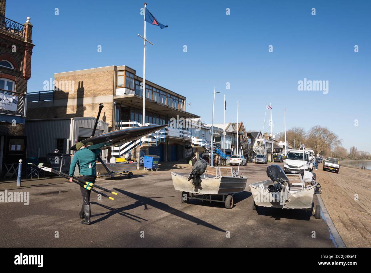 A lone oarsman carries his boat back to the boathouse - Putney ...