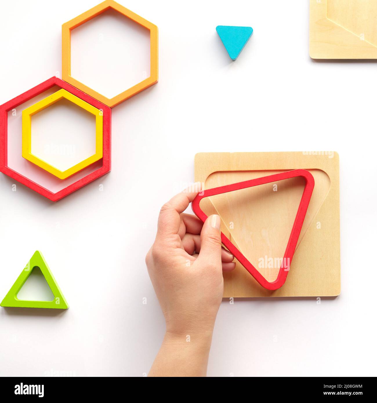 Hands with triangle. Nested wood triangles and hexagons, concentric ...