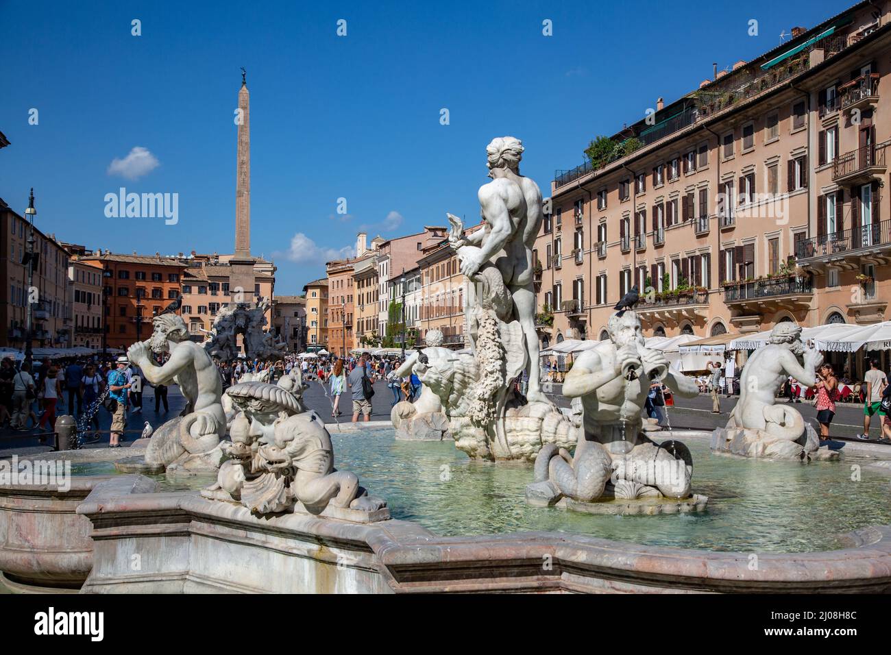 Tourists at Piazza Navona and the sculptures at the fountains, Rome ...