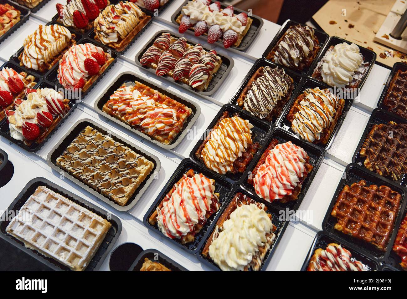 Various of traditional Belgian waffles topped with chocolate, speculoos ...