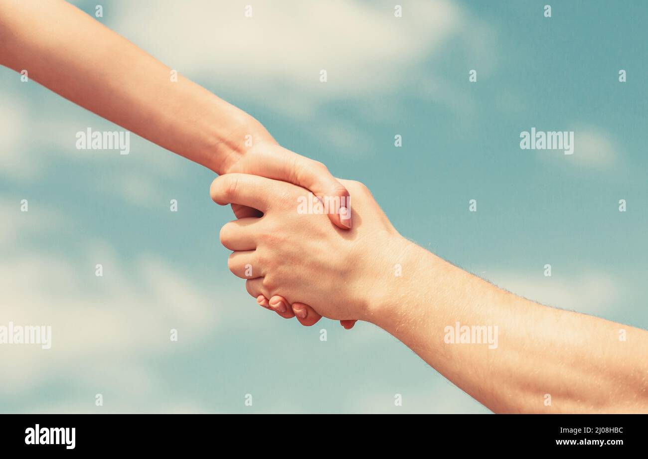 Hands of man and woman reaching to each other, support. Giving a ...
