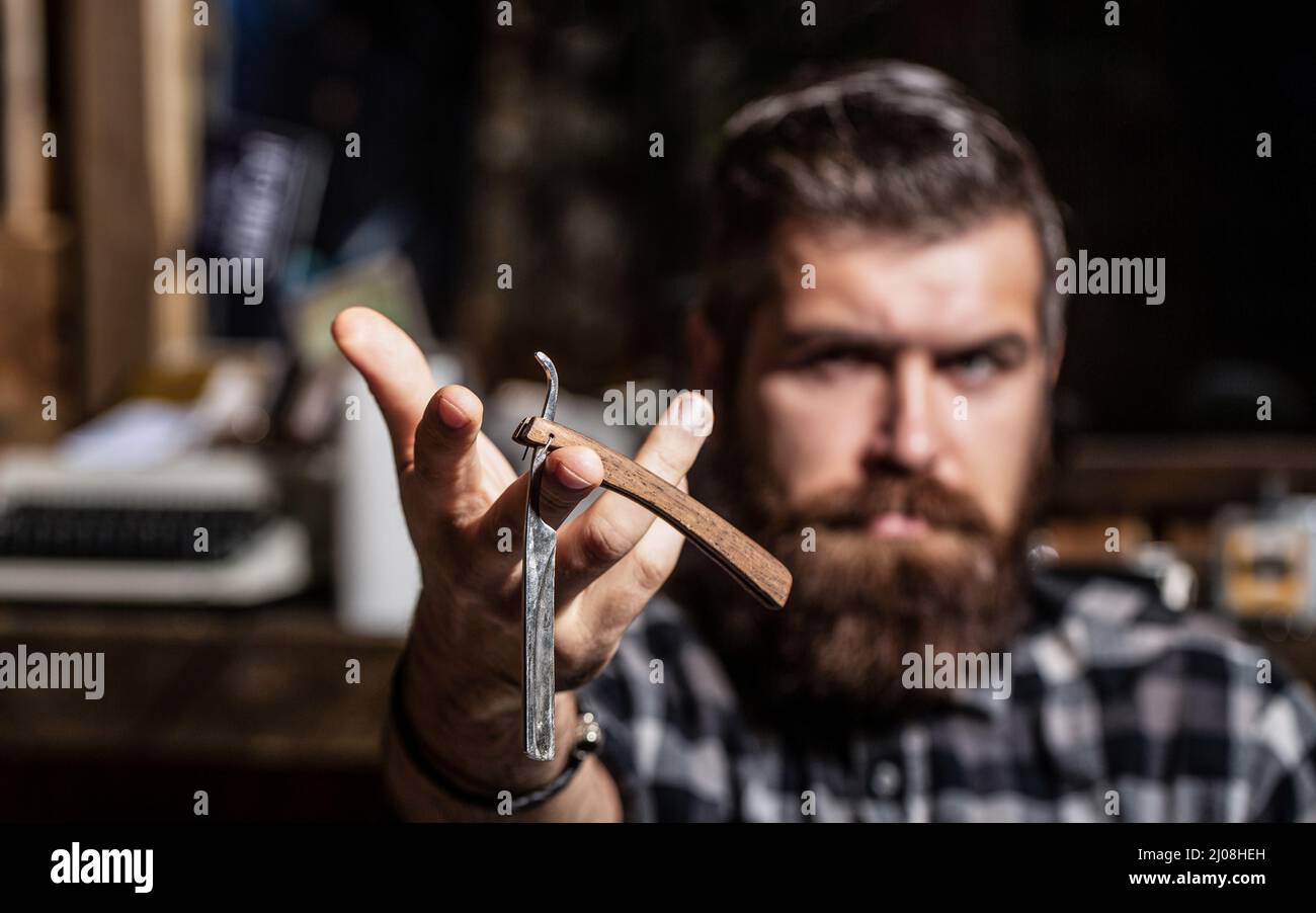 Mens haircut. Man in barbershop. Handsome bearded hairdresser is ...