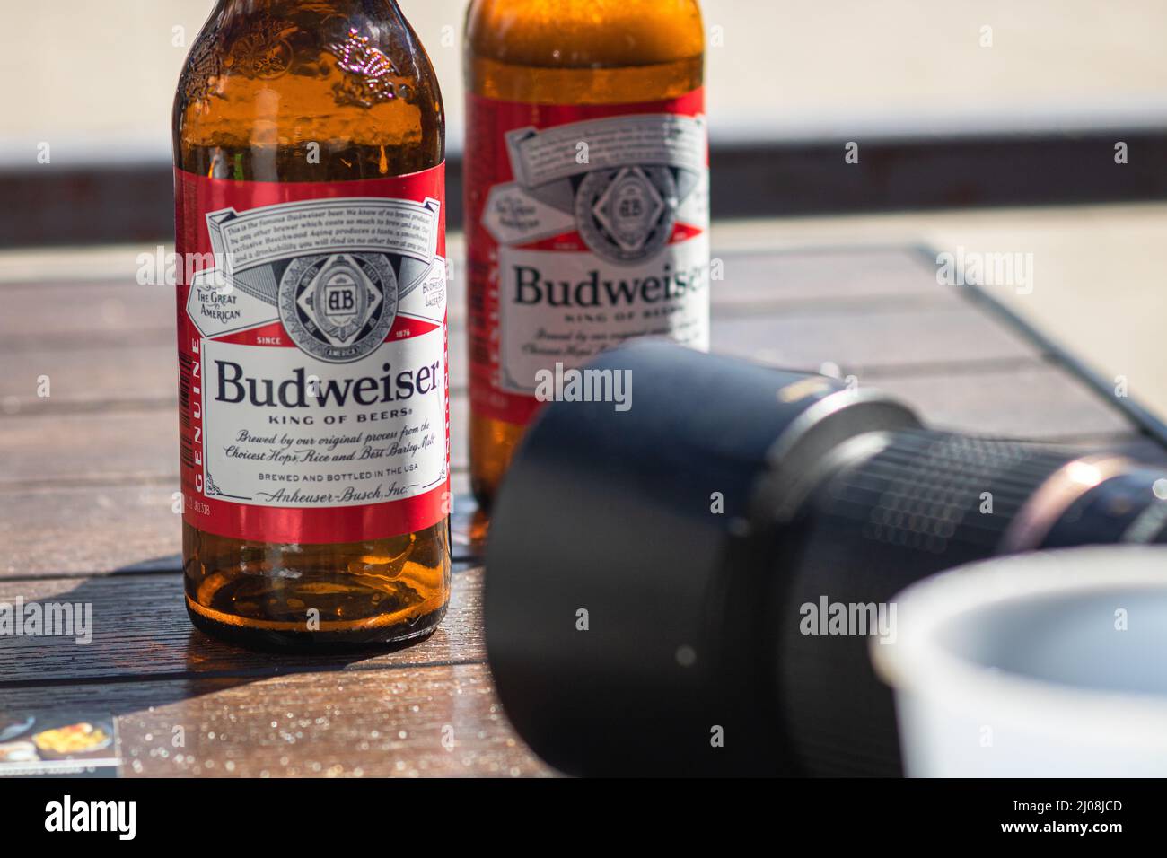 Number of Budweiser bottles with a camera on a blurred background Stock ...