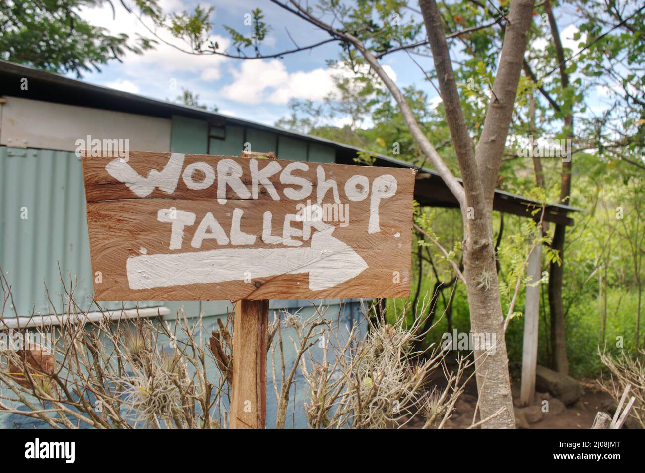 A craft workshop sign written in English and Spanish Stock Photo - Alamy