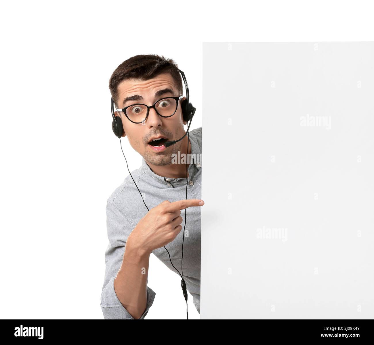 Shocked male consultant of call center pointing at blank paper sheet on ...