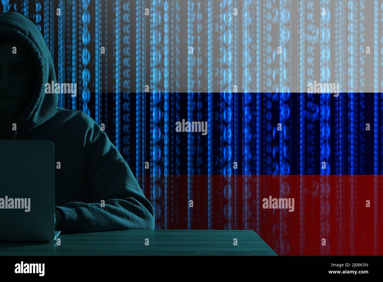 Silhouette of Russian hacker with laptop on dark background with space ...