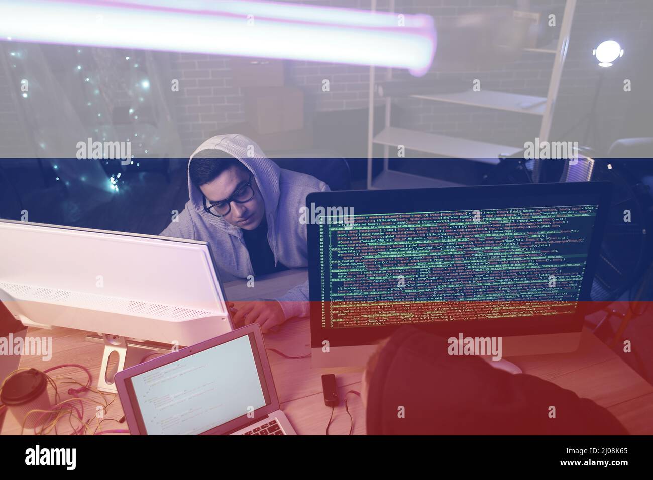 Russian hacker working in dark room Stock Photo - Alamy