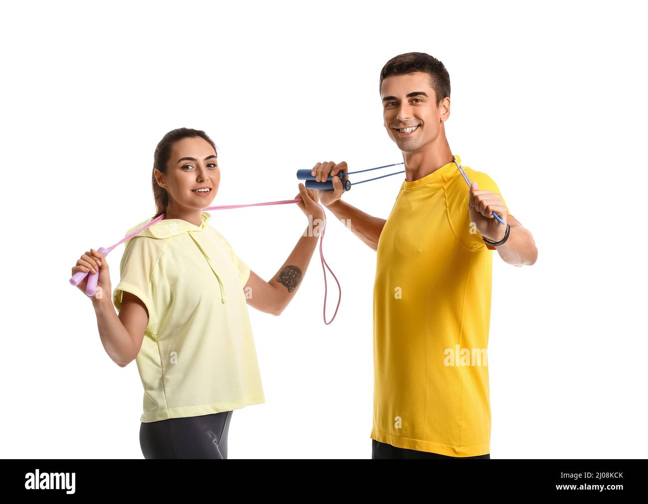 Sporty young couple with jumping ropes on white background Stock Photo ...