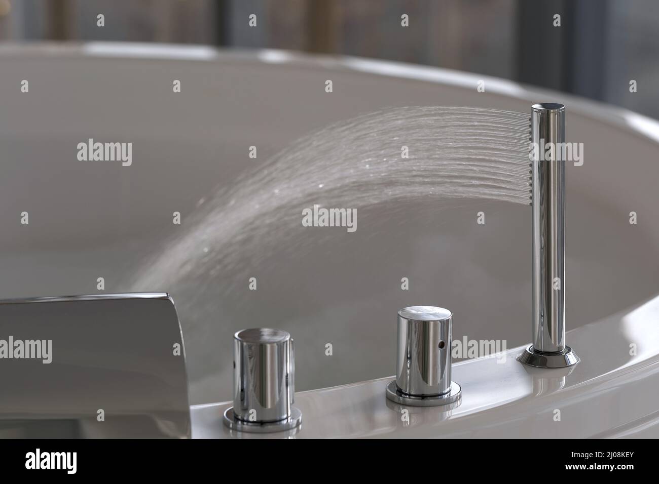Water flows from a luxurious modern water faucet into a large modern ...
