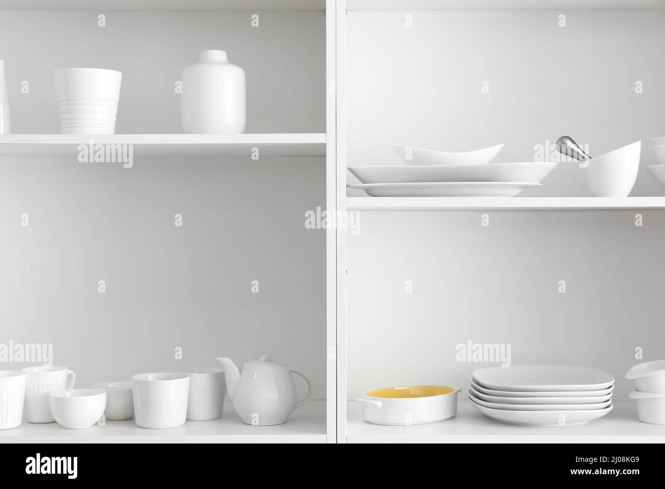 Shelf unit with set of clean dishes in kitchen Stock Photo - Alamy