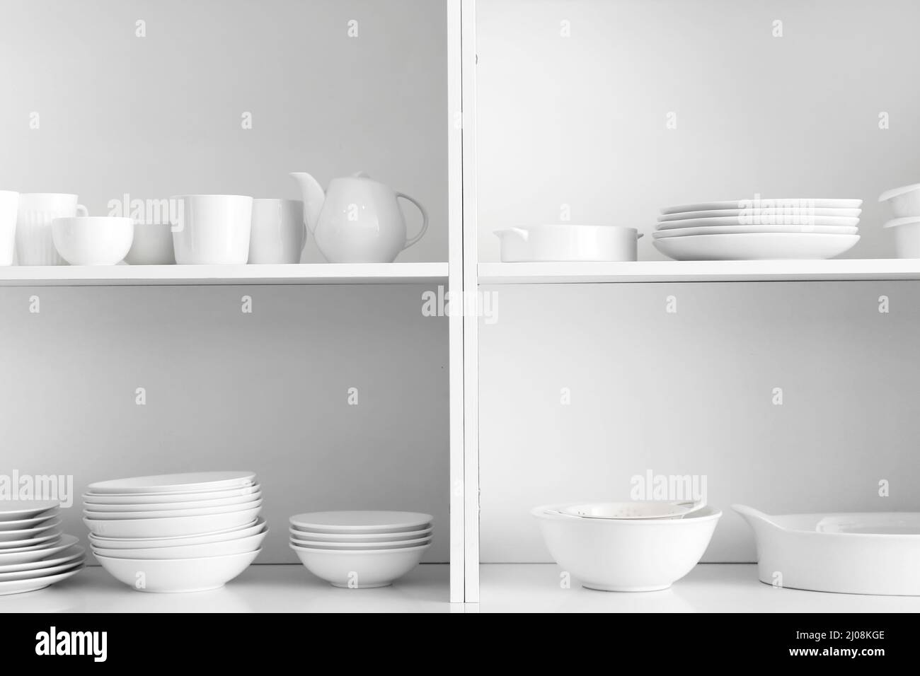 Shelf unit with set of clean dishes in kitchen Stock Photo - Alamy