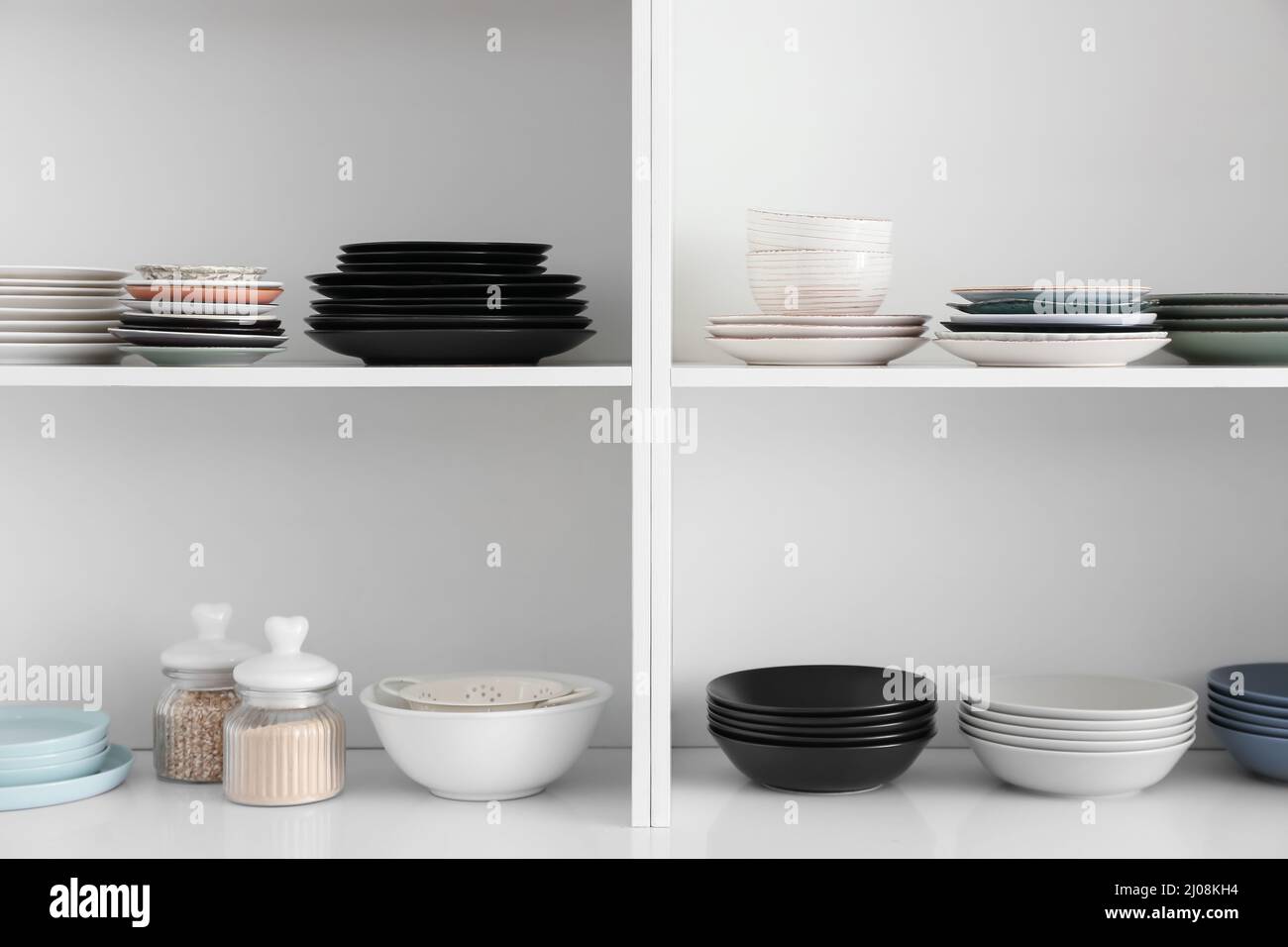 Shelf unit with set of clean dishes in kitchen Stock Photo - Alamy