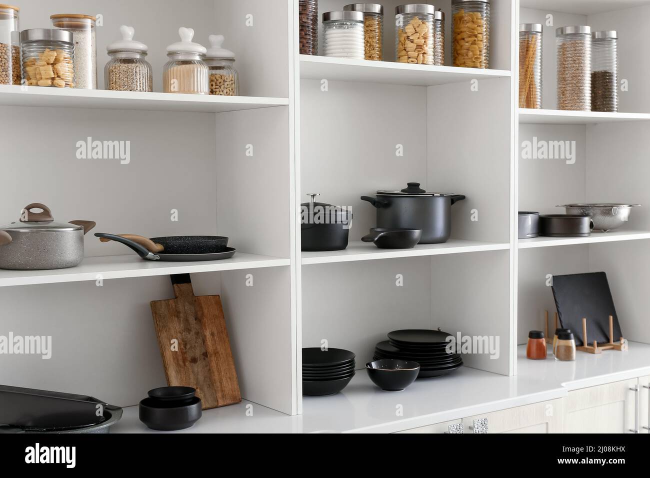 Shelf unit with set of clean dishes in kitchen Stock Photo - Alamy
