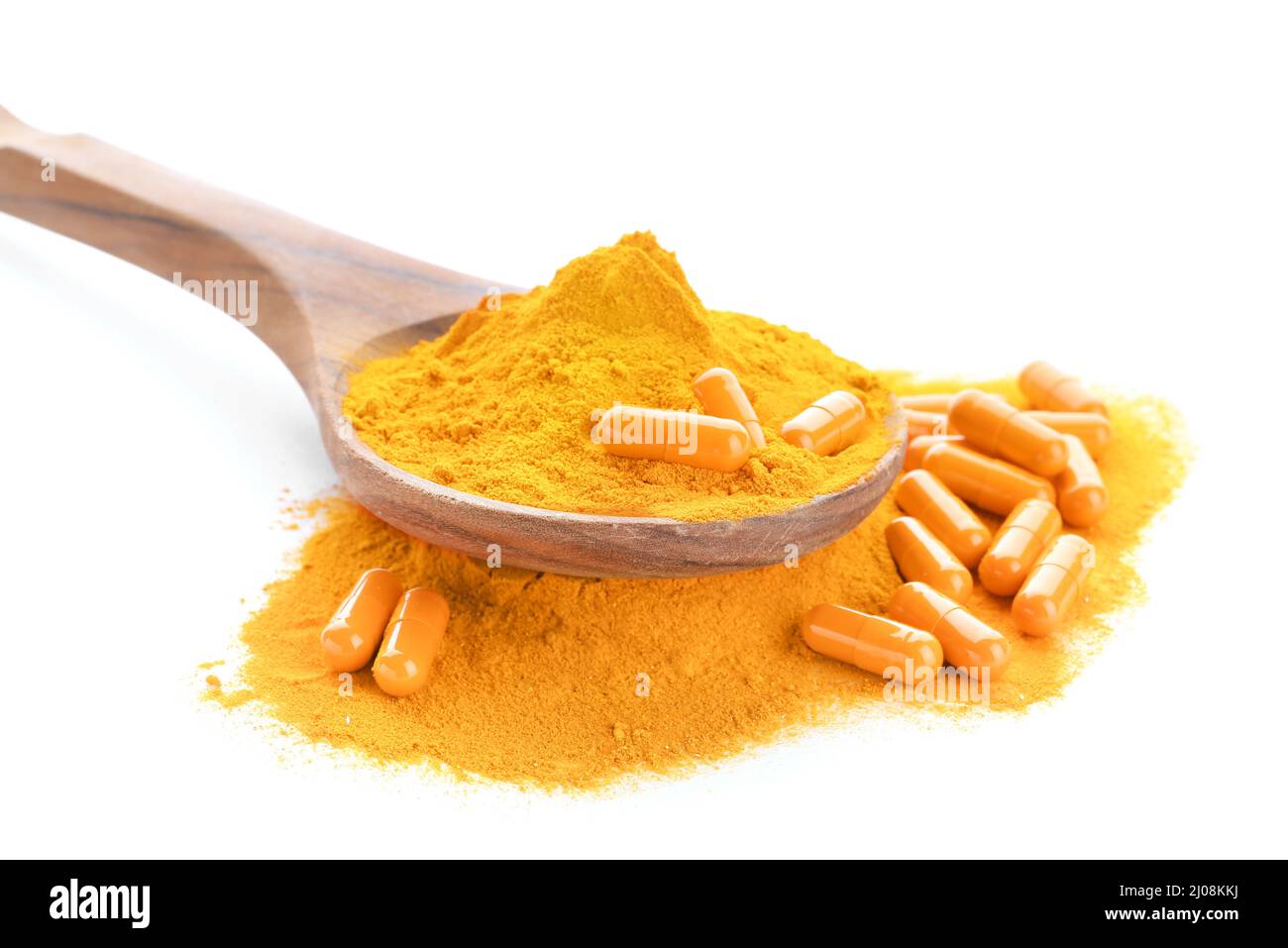 Turmeric powder capsules and spoon on white background, closeup Stock ...