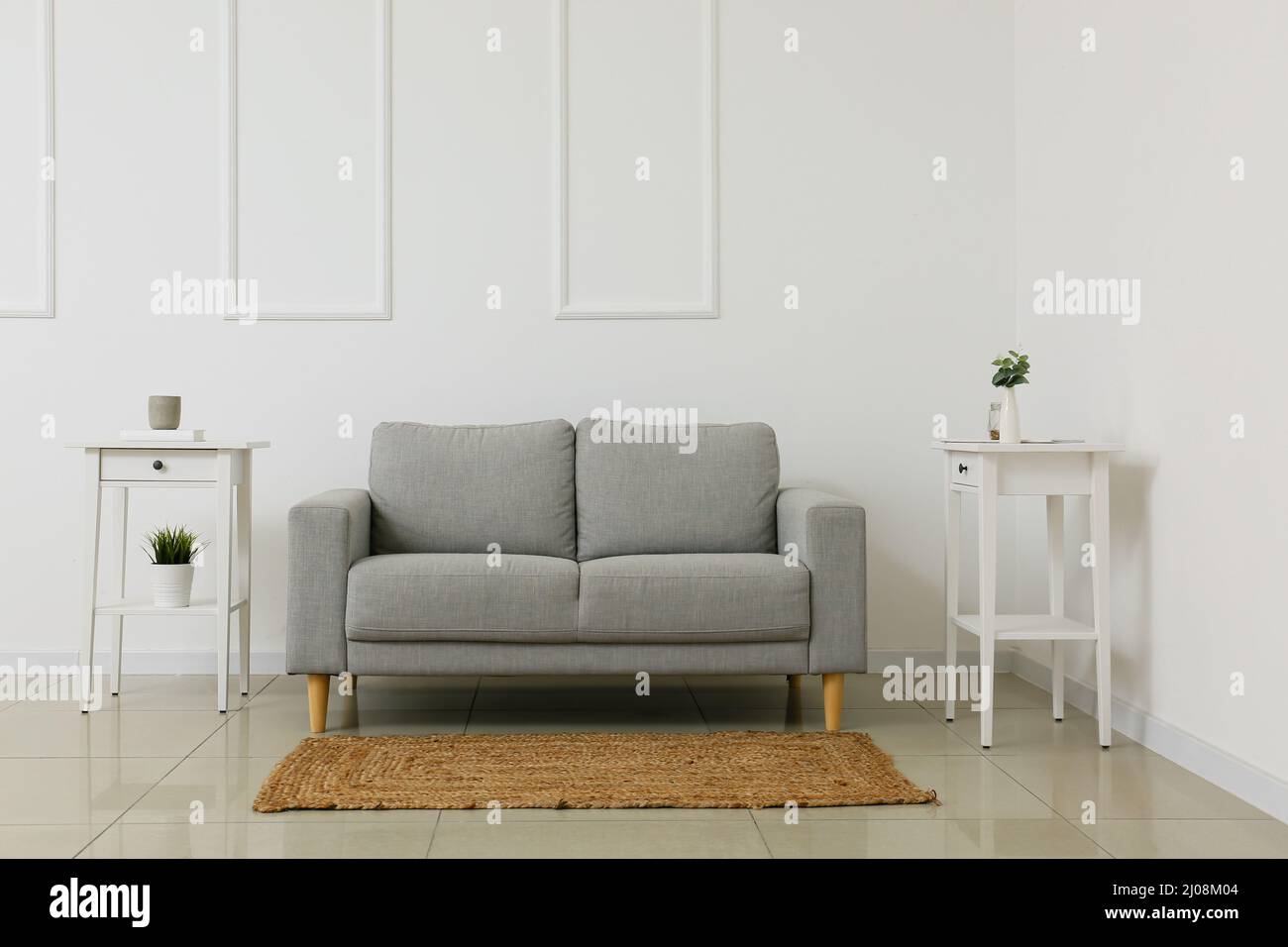 Interior of modern light living room with stylish sofa Stock Photo - Alamy