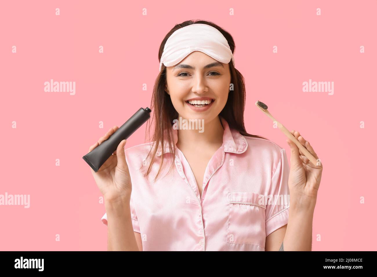 Beautiful young woman with activated charcoal tooth paste and brush on ...