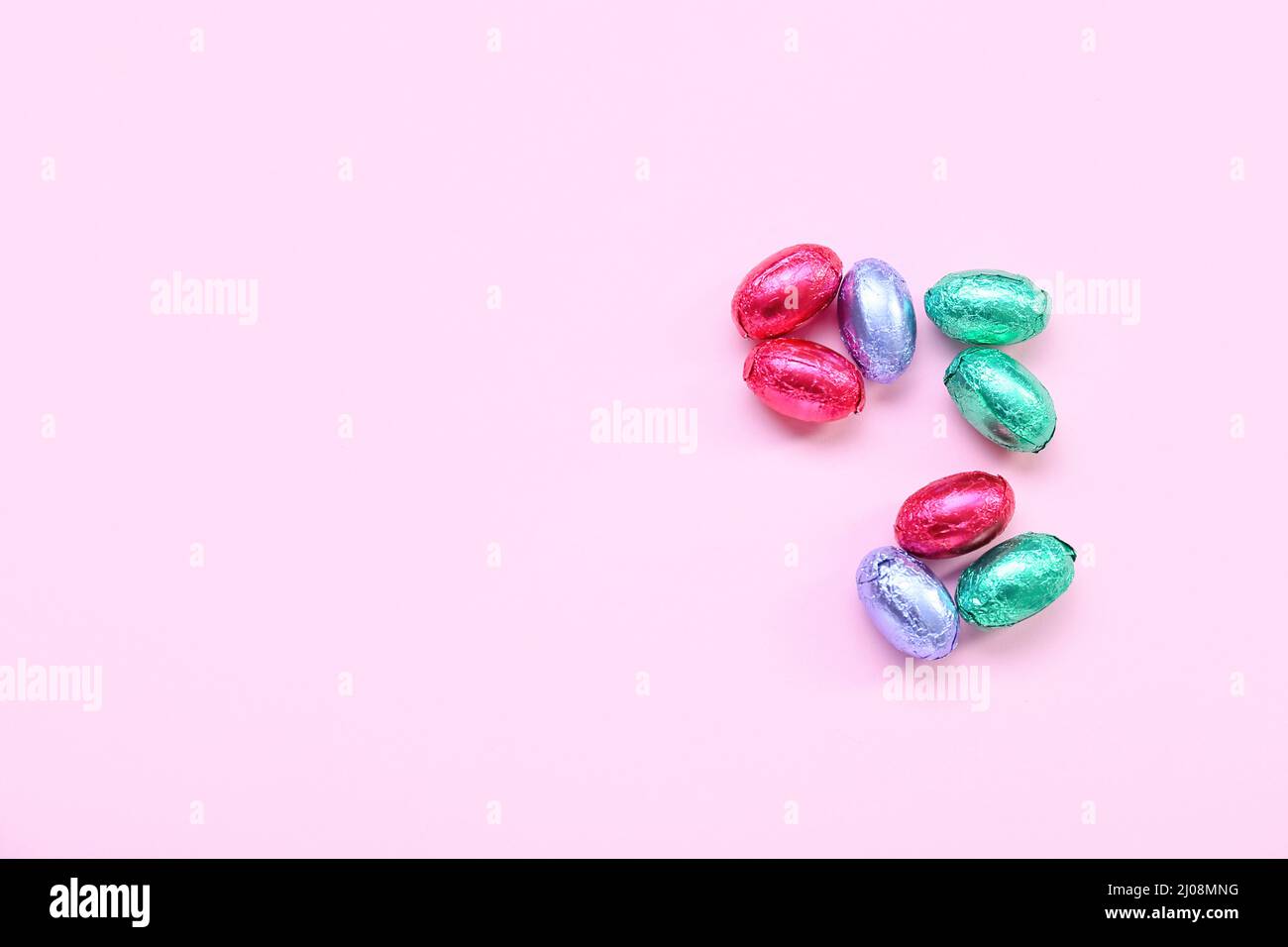 Different chocolate Easter eggs on pink background Stock Photo - Alamy