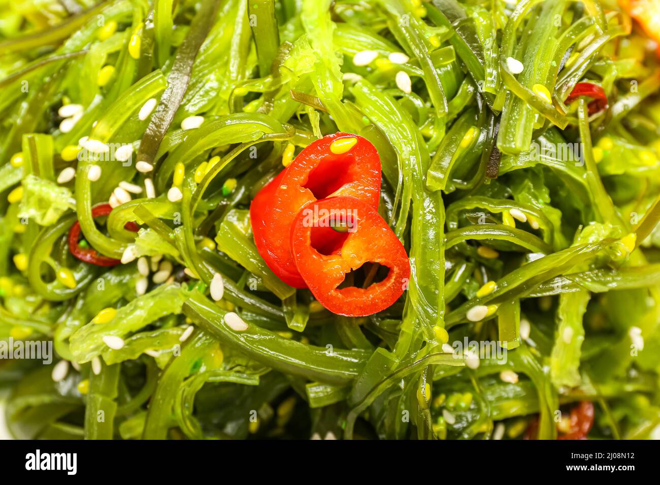Healthy seaweed salad with chili pepper as background Stock Photo - Alamy