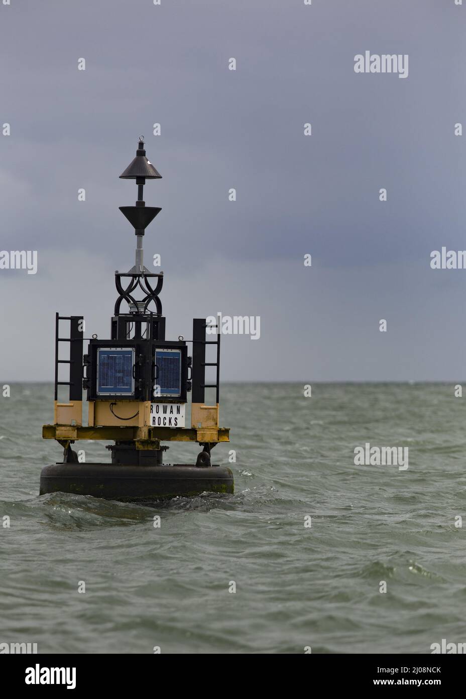 Vertical shot of a weather station floating in the Irish Sea at cloudy ...