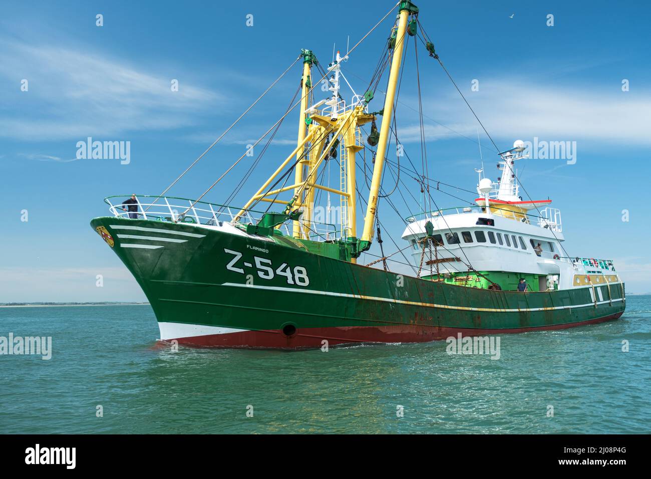 Green fishing vessel entering the Howth port marina on sunny day Stock ...