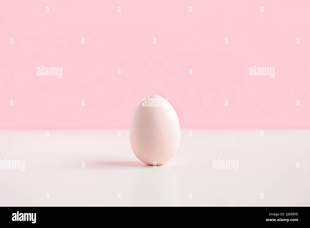 One Easter egg on pink background with copy space for text. Easter ...