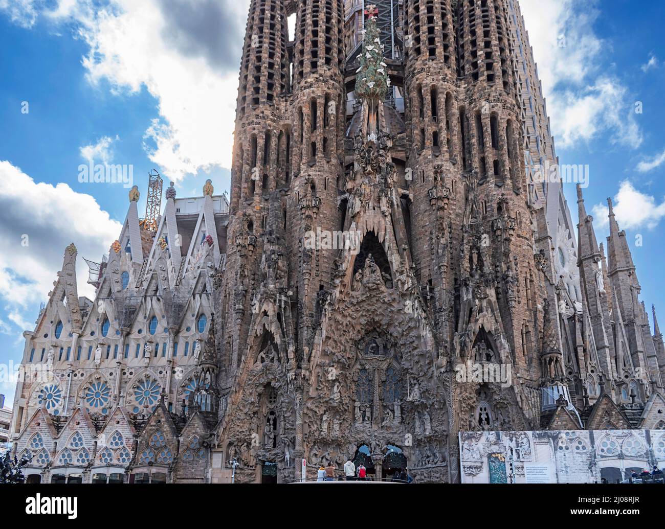 BASILICA i TEMPLE EXPIATORI de la SAGRADA FAMILIA BARCELONA SPAIN THE NATIVITY FACADE AND A BLUE ...
