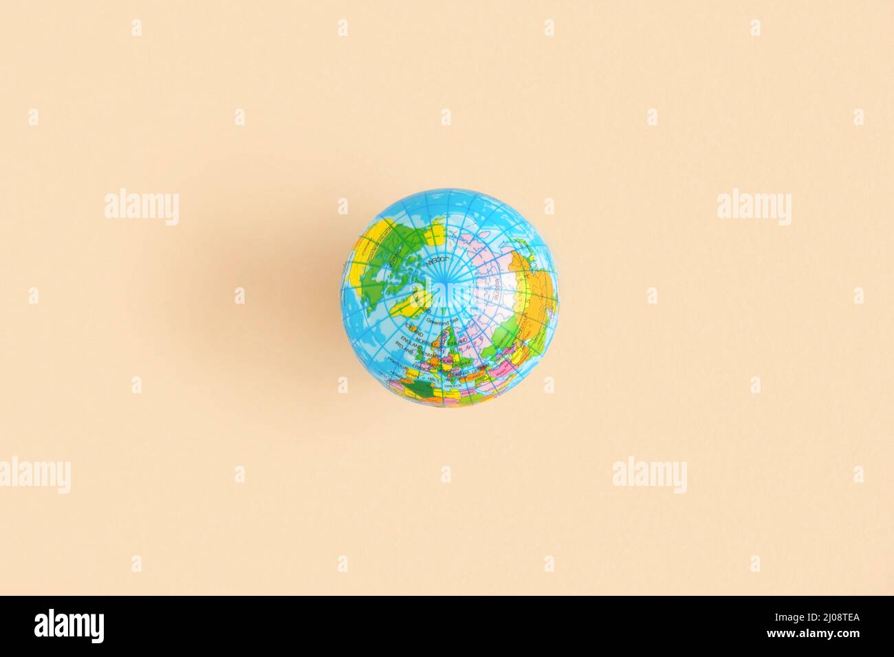 Earth globe on isolated beige pastel background. Civilization. Top view ...