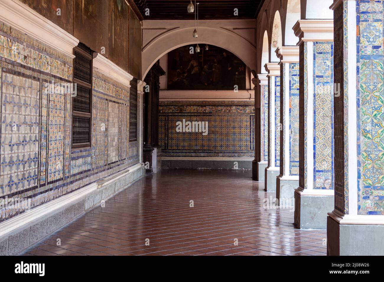 Hall with ornated walls and arched columns in the courtyard of Santo ...