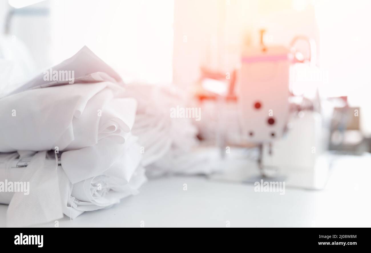 Closeup sewing machine with thread, background white color sun light ...