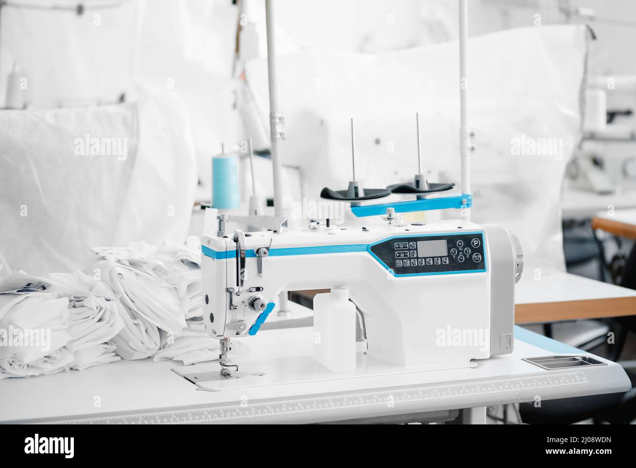 Concept Interior of garment factory. Automatic machine for embroidering ...