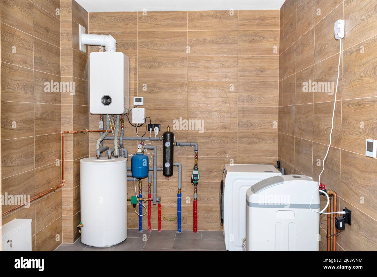 A modern gas boiler room lined with ceramic tiles imitating wood ...