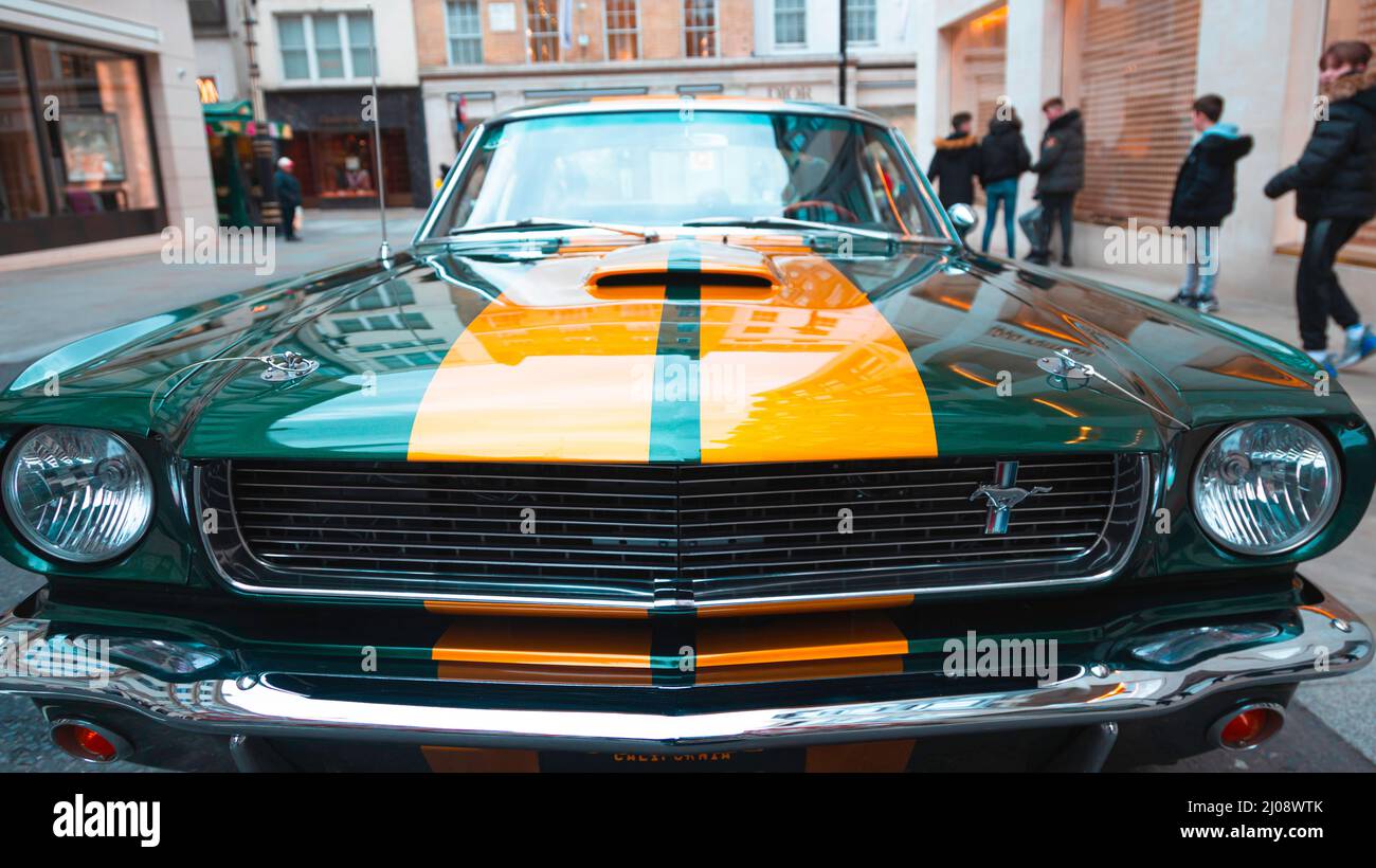 Classic green Ford Mustang with yellow stripes in the city of London ...