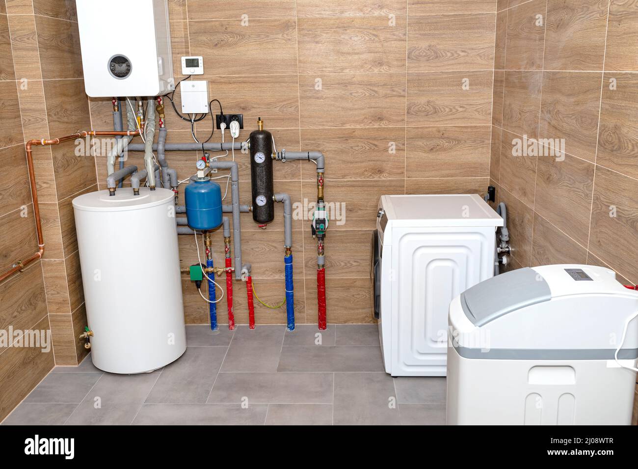 A modern gas boiler room lined with ceramic tiles imitating wood ...