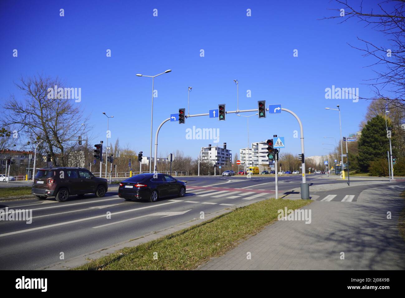 Cars waiting in front of traffic lights for different directions in the ...