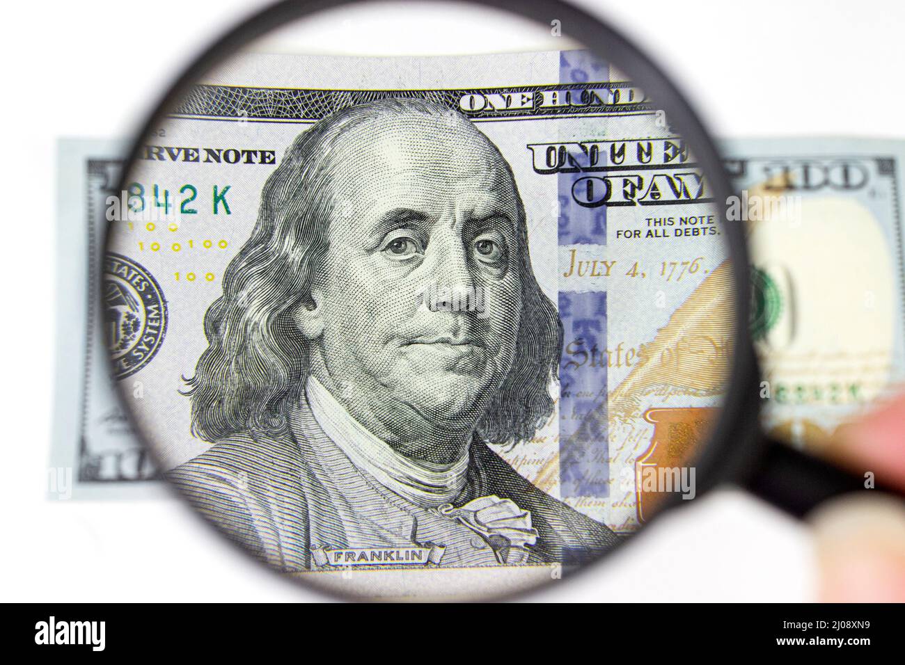 Magnifying glass on dollar banknotes. Finance and business. Hundred ...