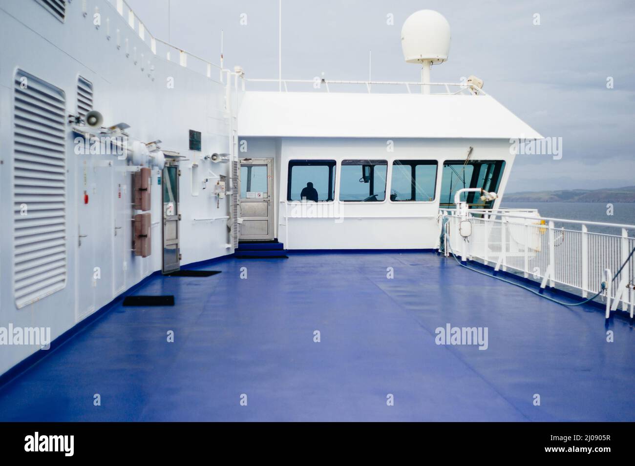 Navigational bridge with an officer of the watch on an Irish Sea ferry ...