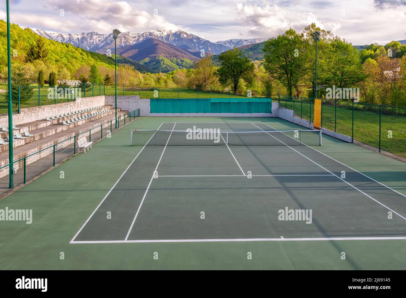 Tennis court. Trees and mountains around the tennis court in nature ...