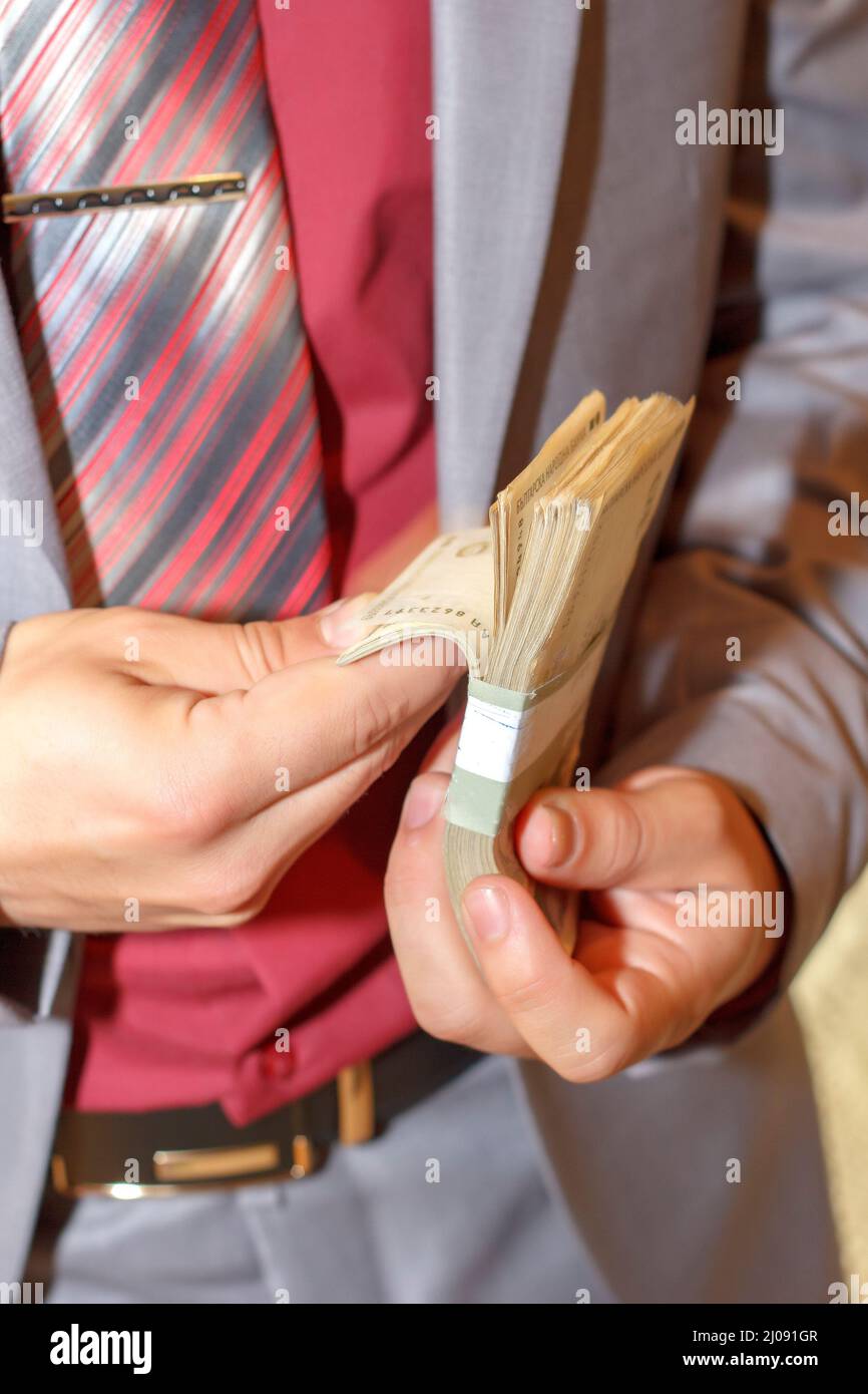Man check and count money with your hands. Vertical view Stock Photo ...