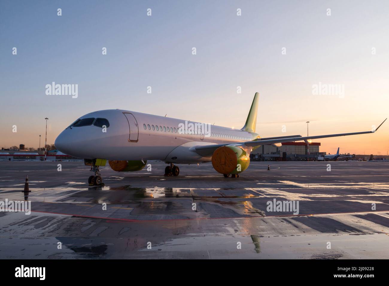 Modern passenger airplane on the airport apron at the evening light ...