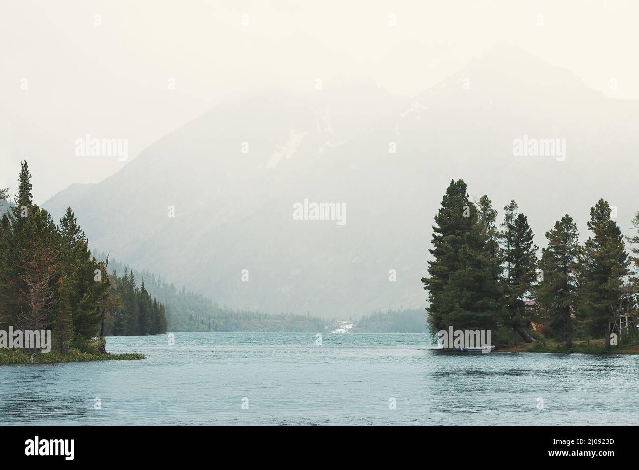 Atmospheric and moody landscape of lower Multa Lake at misty and cloudy ...