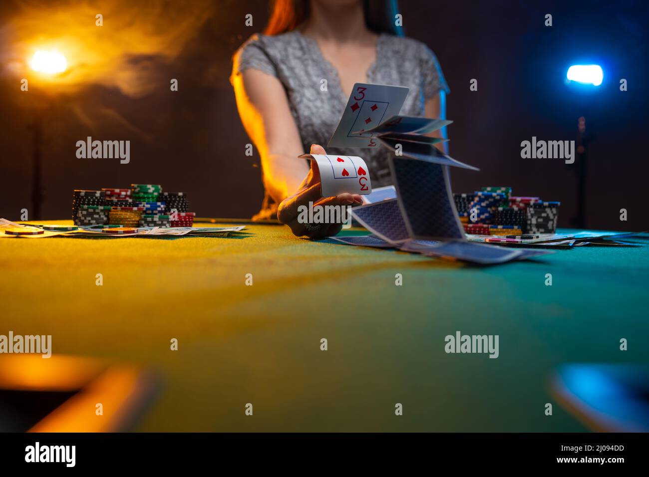 Close-up view of gambler woman siting at the table in casino and throws ...