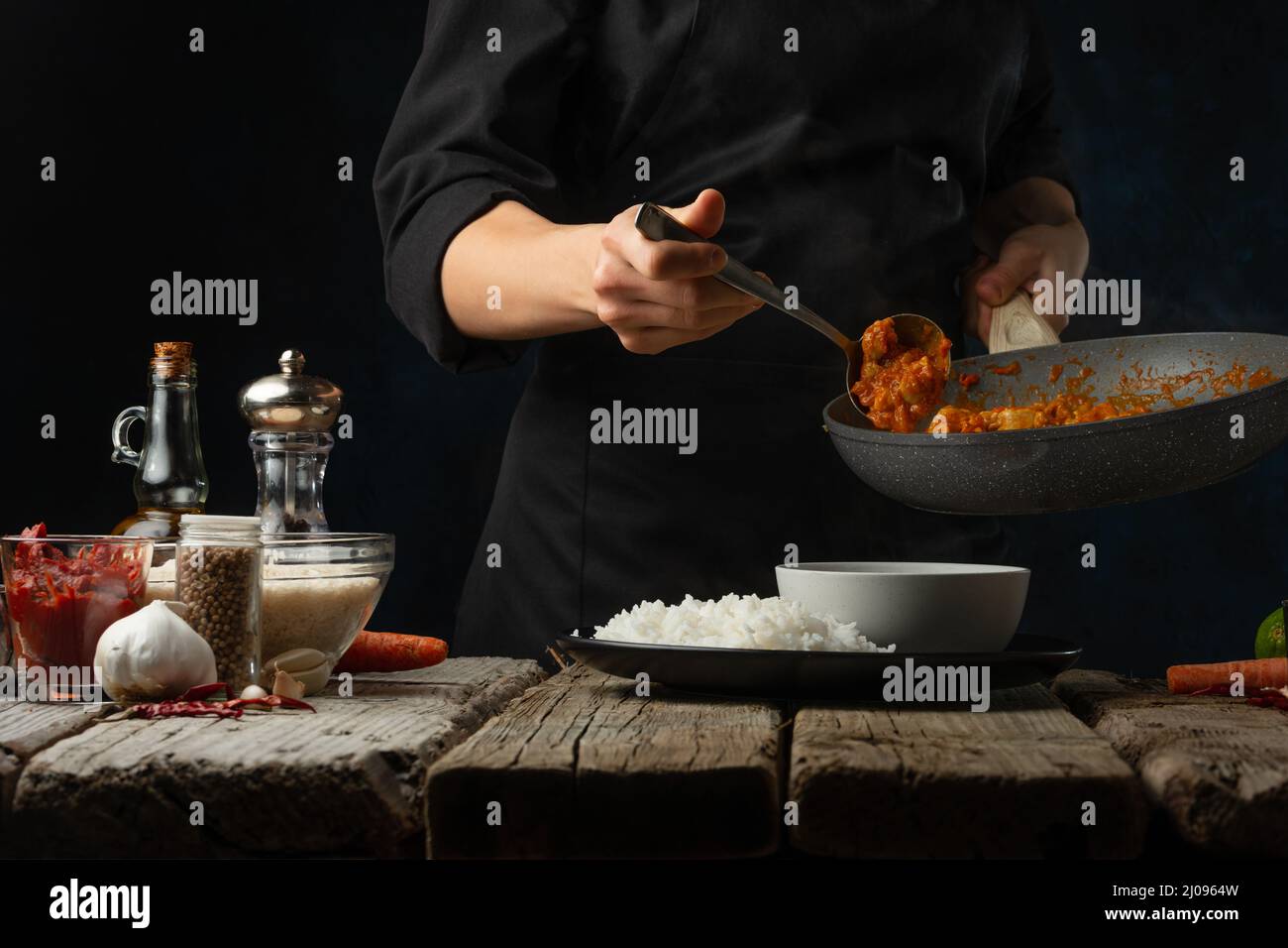 Professional chef stir ingredients in frying pan. Backstage of cooking ...