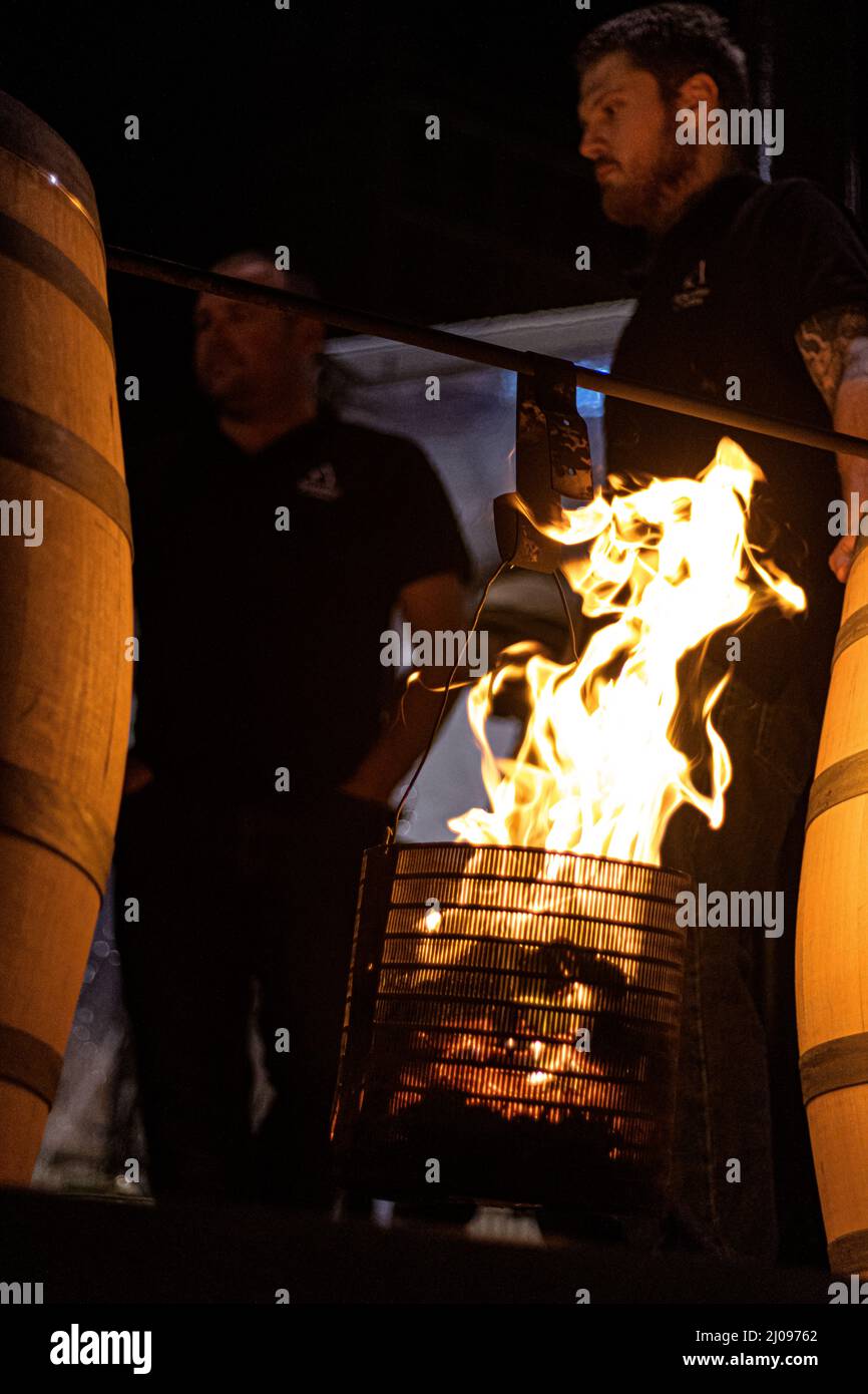 Man burning the inside of a wooden barrel Stock Photo - Alamy