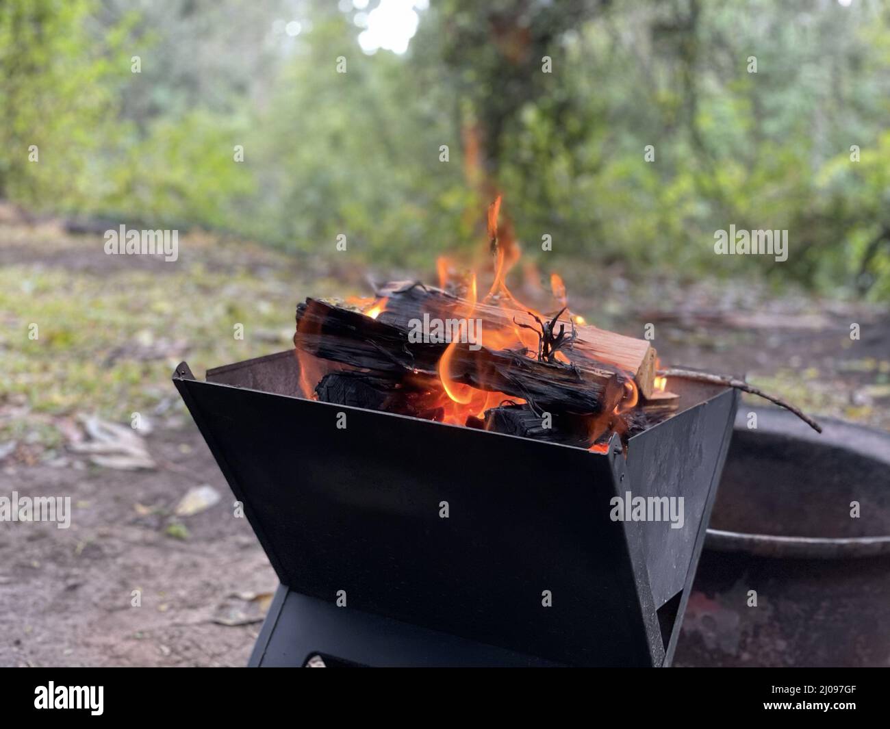 Closeup shot of fire burning in the iron mangal in nature background ...