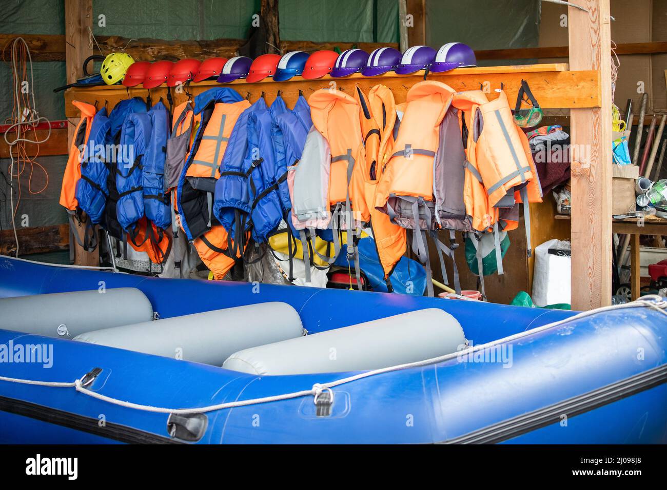 Rafting equipment - rubber boat and helmets with life jackets Stock ...
