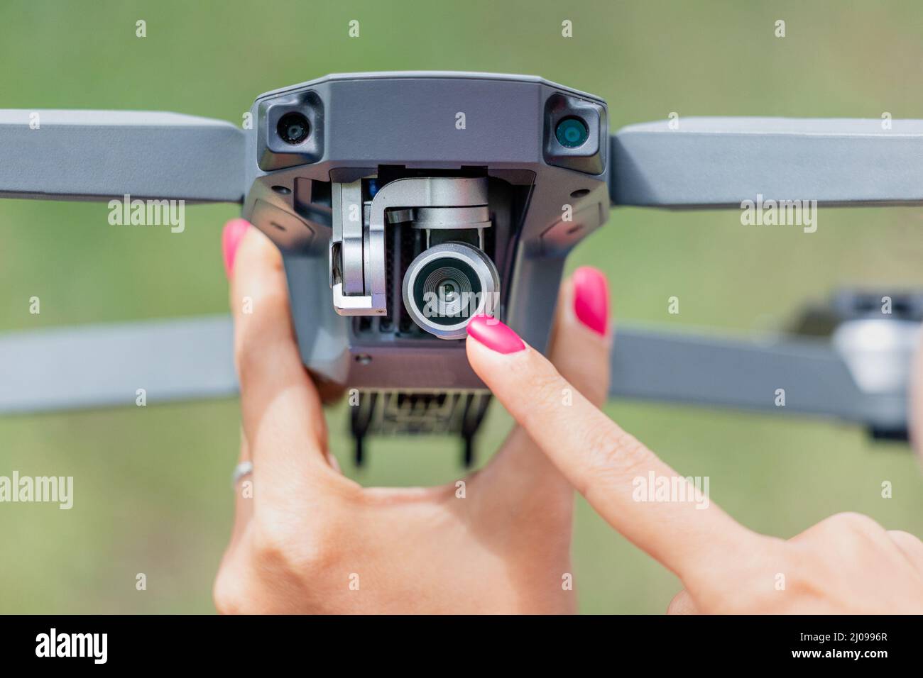 Female hands hold the ua drone and check the functionality of the ...